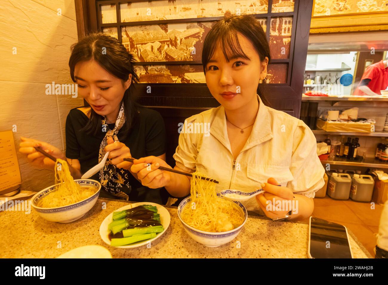 China, Hong Kong, Hong Kong Island, Central, Two young Asian woman ...