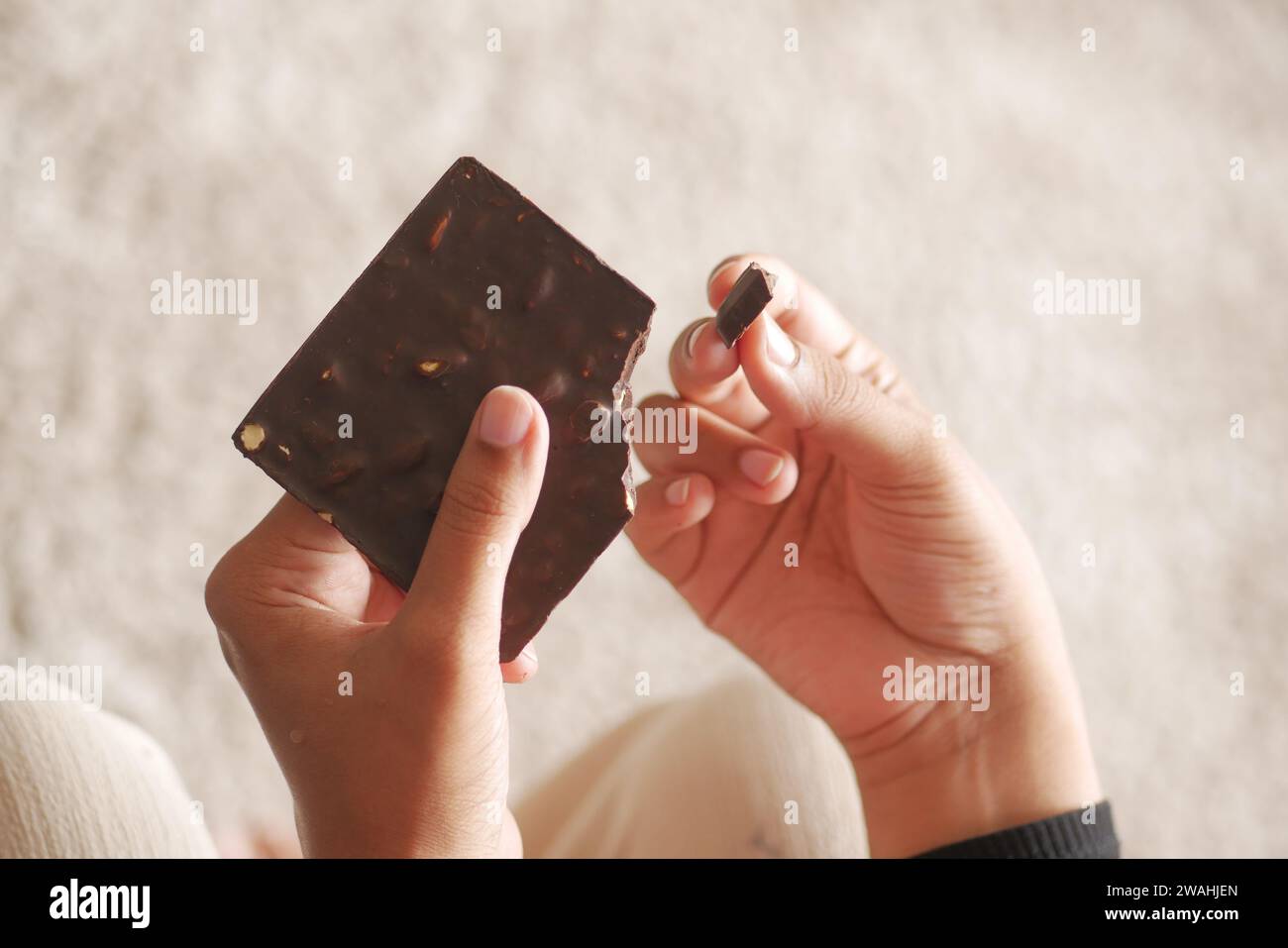 Hand breaking chocolate bar hi-res stock photography and images - Alamy
