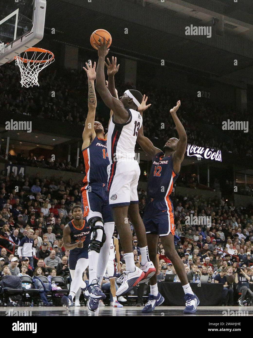 Gonzaga forward Graham Ike (13) shoots between Pepperdine forwards ...
