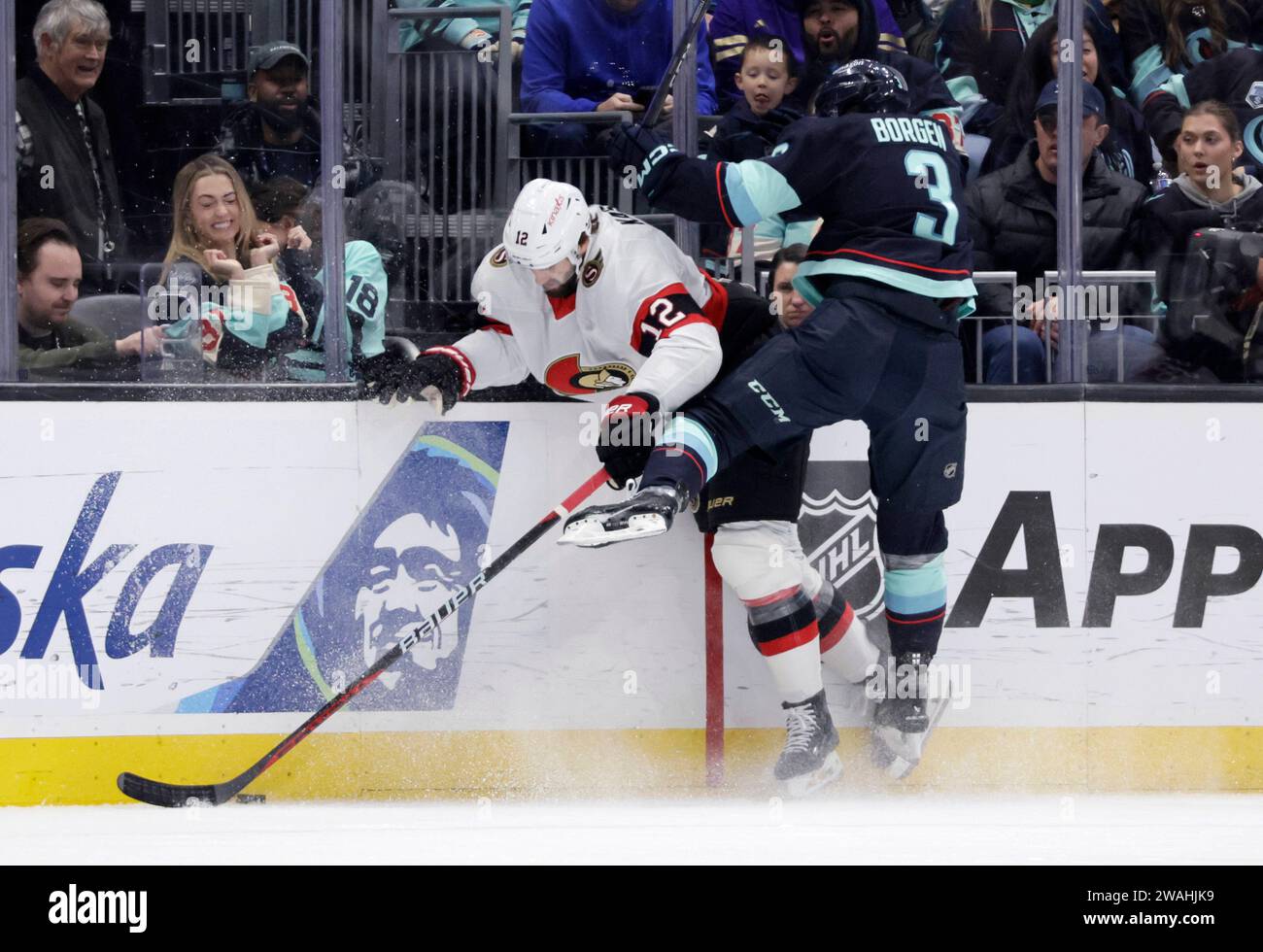 Seattle Kraken defenseman Will Borgen (3) checks Ottawa Senators center ...
