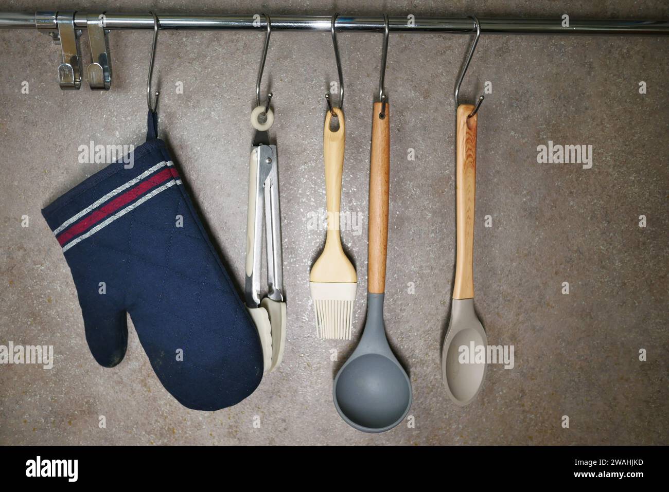 Cooking utensils hanging out with copy space Stock Photo - Alamy