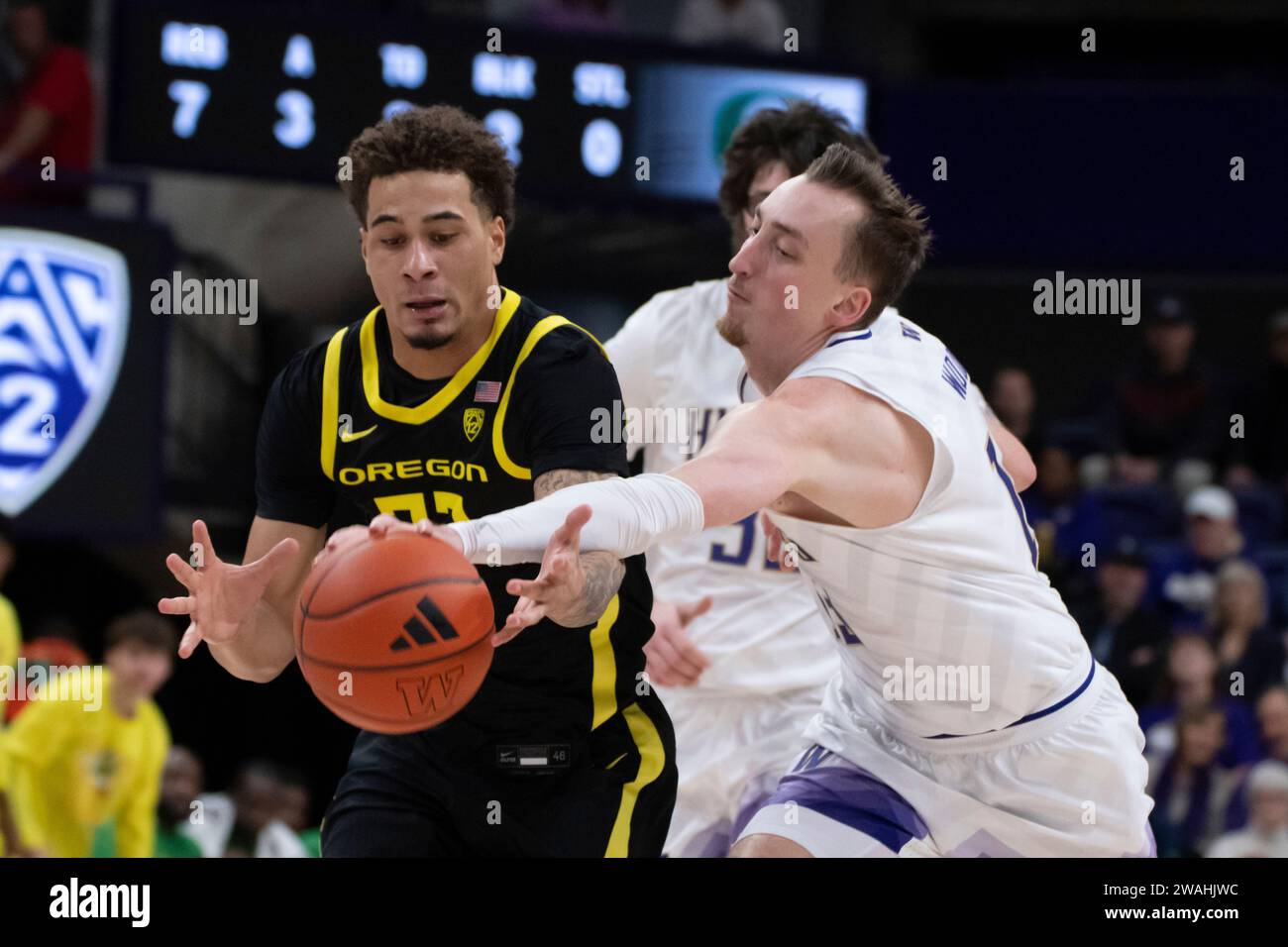 Washington forward Moses Wood, right, fouls Oregon guard Jadrian Tracey ...