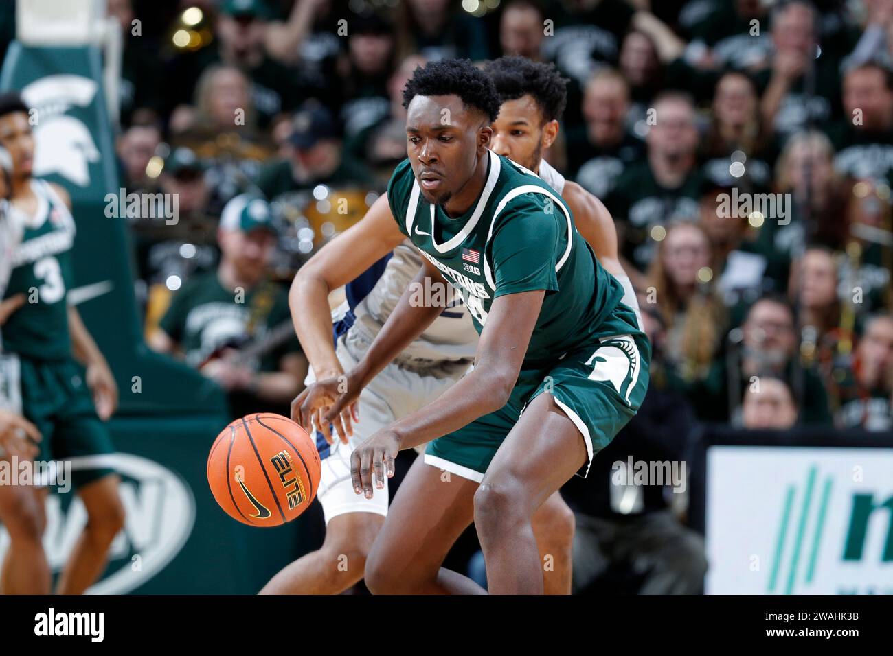 Michigan State forward Xavier Booker reaches for the ball during an NCAA college basketball game ...