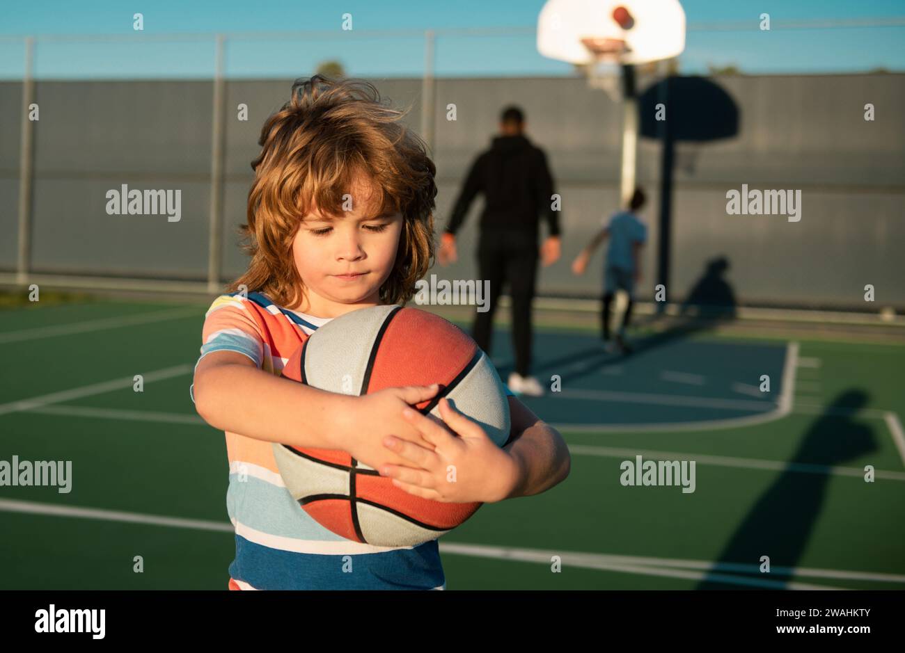 Cute smiling boy plays basketball. Active kids enjoying outdoor game ...