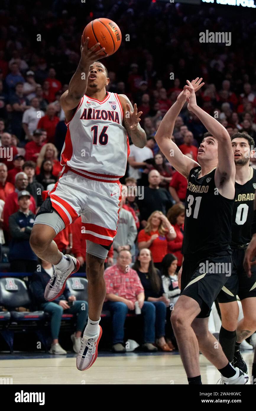 Arizona forward Keshad Johnson (16) drives past Colorado players during ...