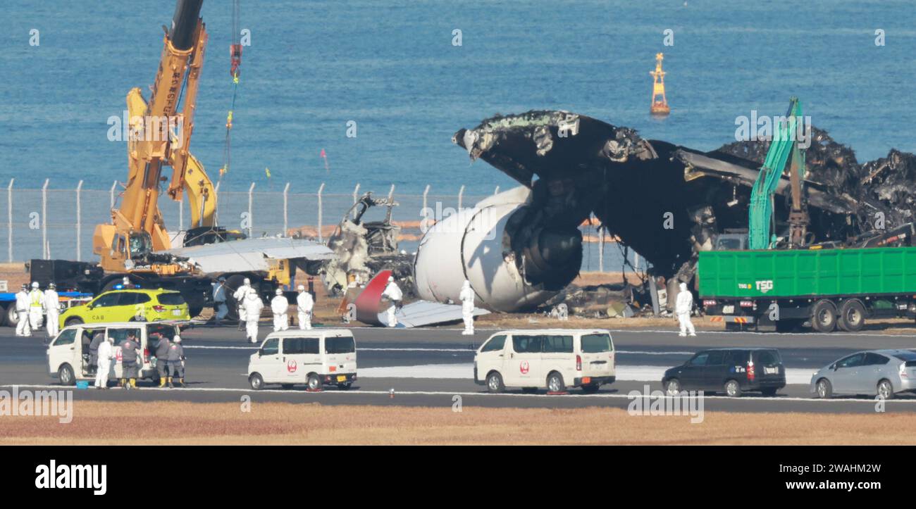 A removing work of a burnt Japan Airlines Flight 516 remains on the ...