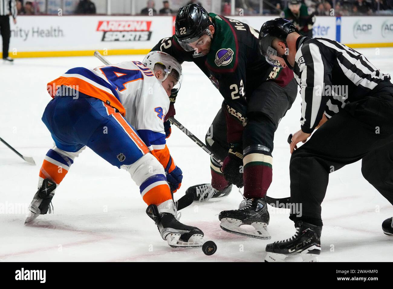 New York Islanders center Jean-Gabriel Pageau, left, works Arizona ...