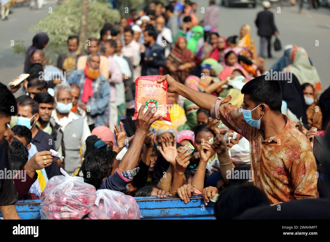Dhaka, Bangladesh. 04th Jan, 2024. People wait in a line to buy daily ...
