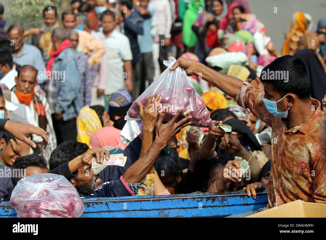 Dhaka, Bangladesh. 04th Jan, 2024. People wait in a line to buy daily ...
