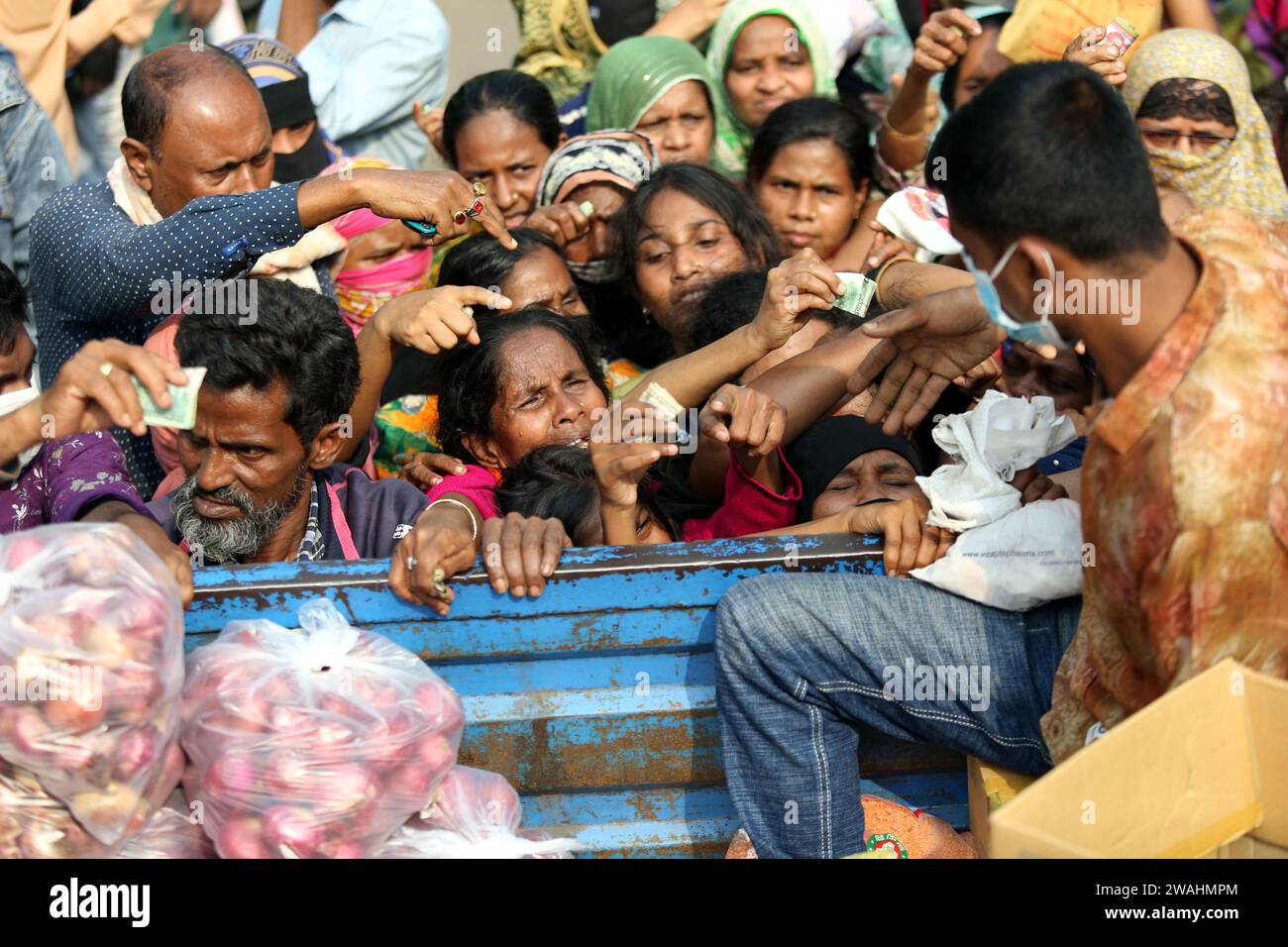 Dhaka, Bangladesh. 04th Jan, 2024. People wait in a line to buy daily ...