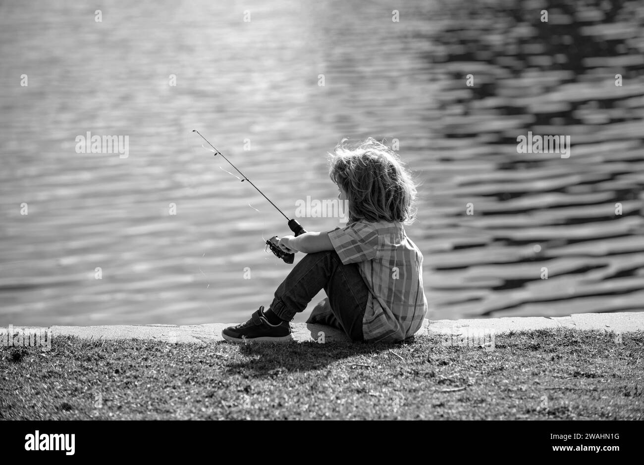 Fishing hobby. Child fishing on the lake. Boy with spinner at river ...