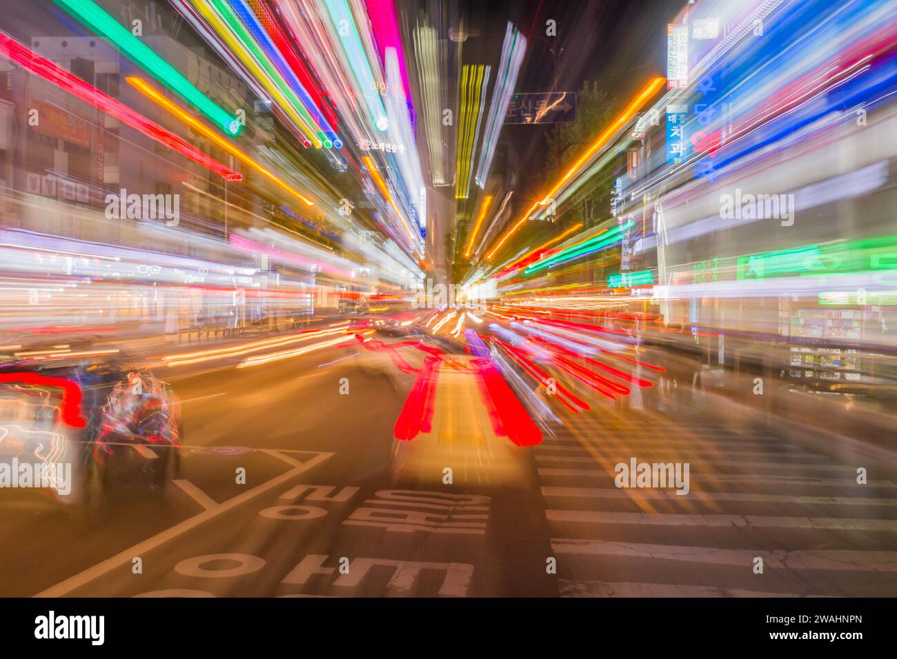 Light trails created using zoom photography in busy downtown district ...