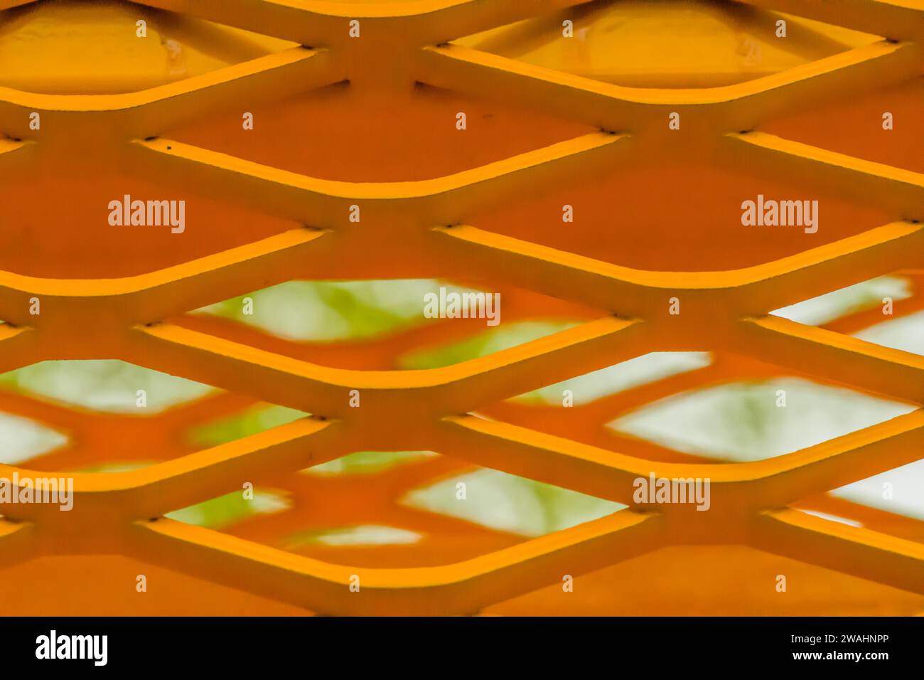 Macro of yellow metal grate with blurred background Stock Photo - Alamy