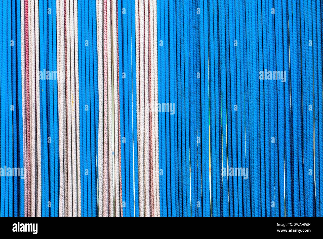 Lengths of blue and white ropes hanging vertically like a curtain Stock ...