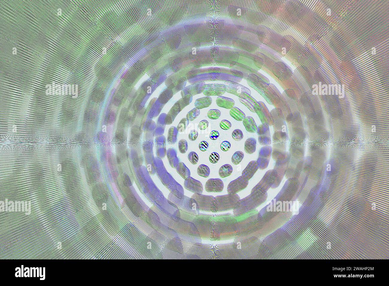 Circular pattern in reds, greens and blues with small holes in center ...