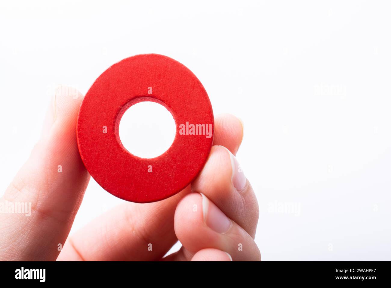 Hand holding letter cube O of made of wood Stock Photo - Alamy