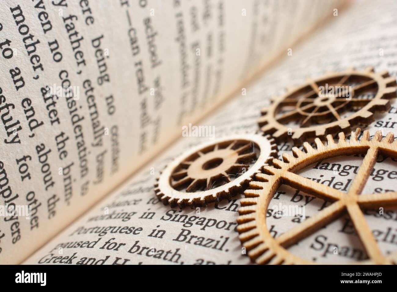 The concept of business gear wheels placed on book page Stock Photo - Alamy
