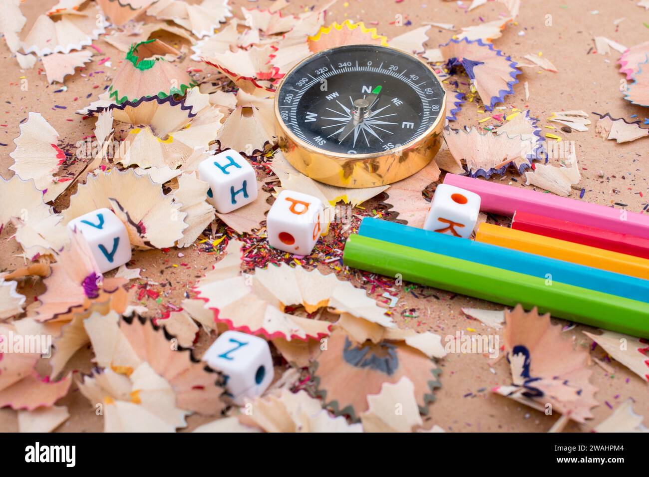 The compass instrument and a few colorful pencils Stock Photo - Alamy
