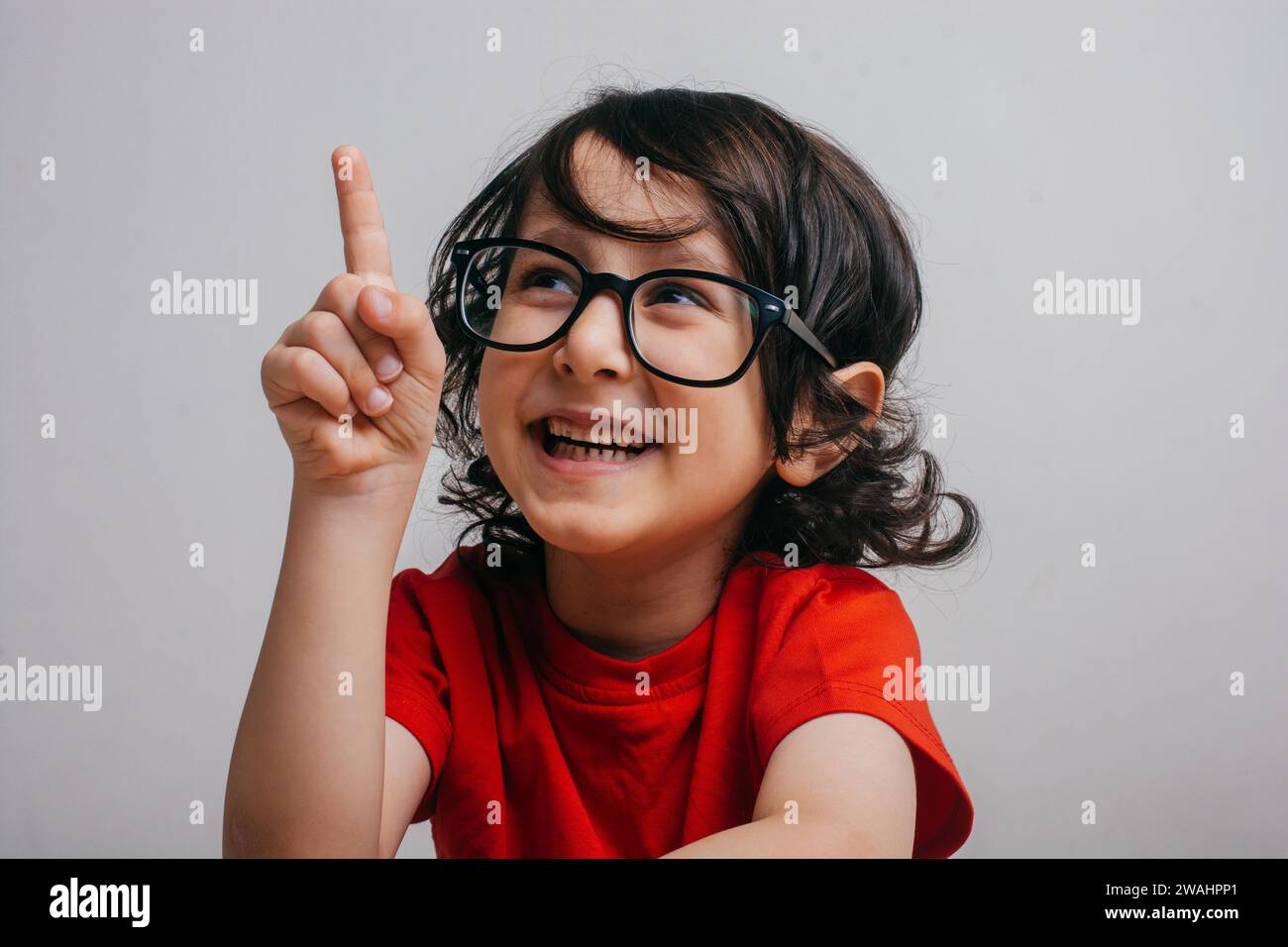 Smiling Little boy raising his hand isolated background Stock Photo - Alamy