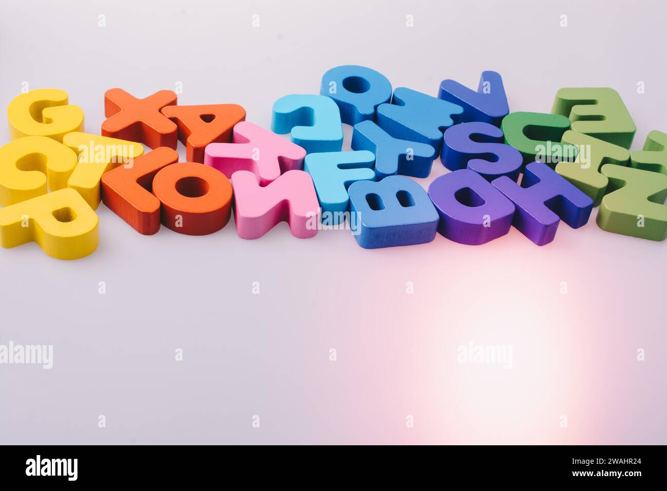 Colorful alphabet letter blocks scattered randomly on white background ...