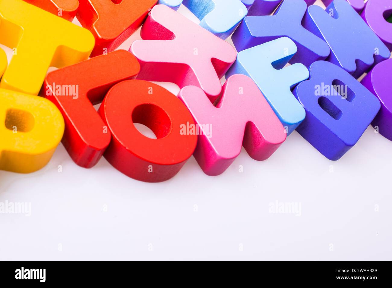 Colorful alphabet letter blocks scattered randomly on white background ...