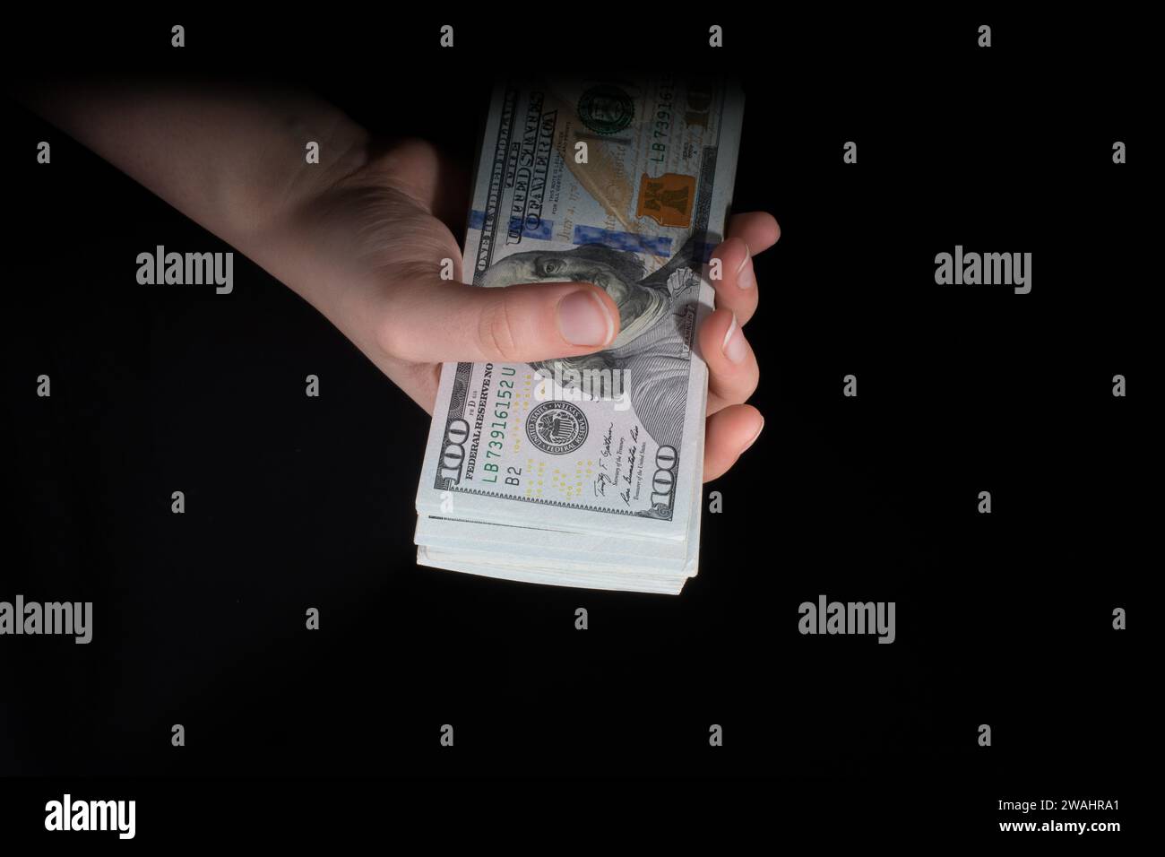 Hand holding American dollar banknotes isolated on white background ...