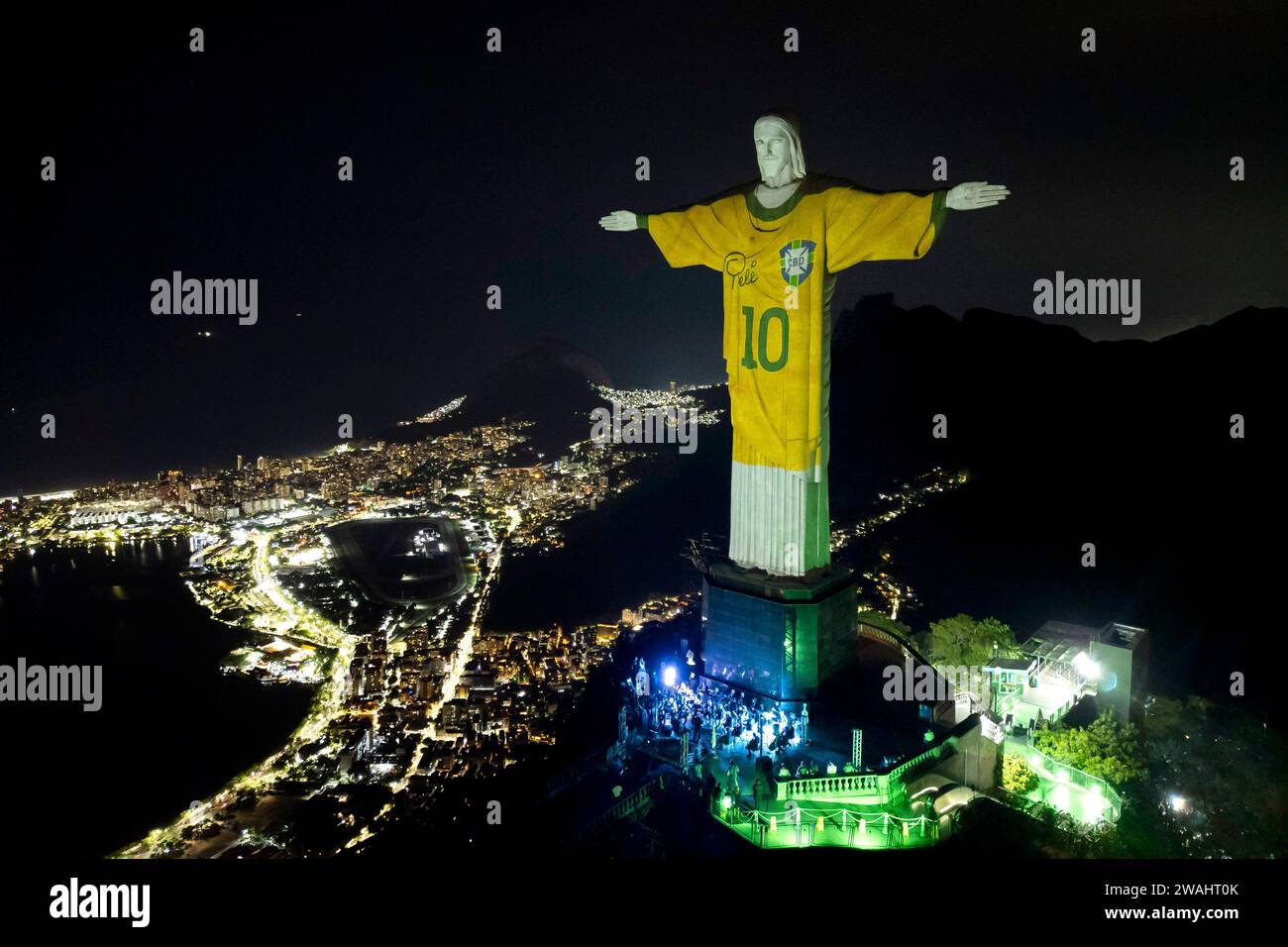The Christ the Redeemer statue is illuminated with an image of Pele's ...