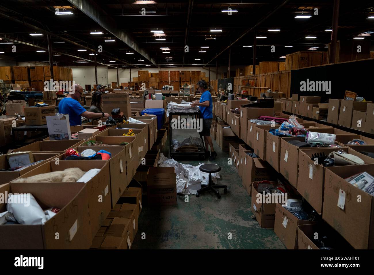 Auction workers sort items at a Los Angeles County warehouse in the ...