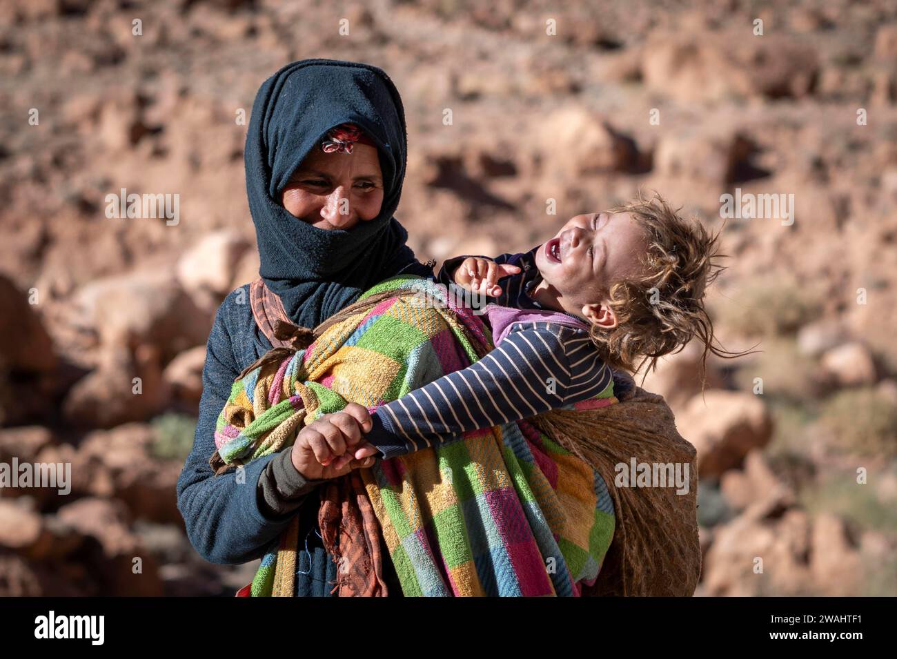 Berber woman, with baby on her back, traditional clothing, Morocco ...