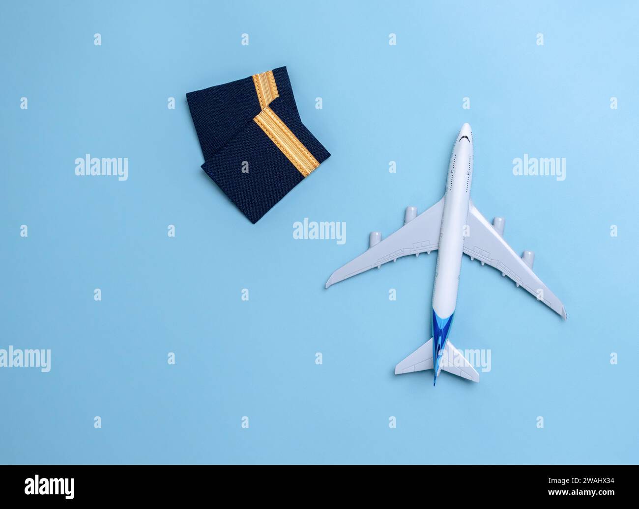 A plane model and pilot rank as first officer isolated on blue ...