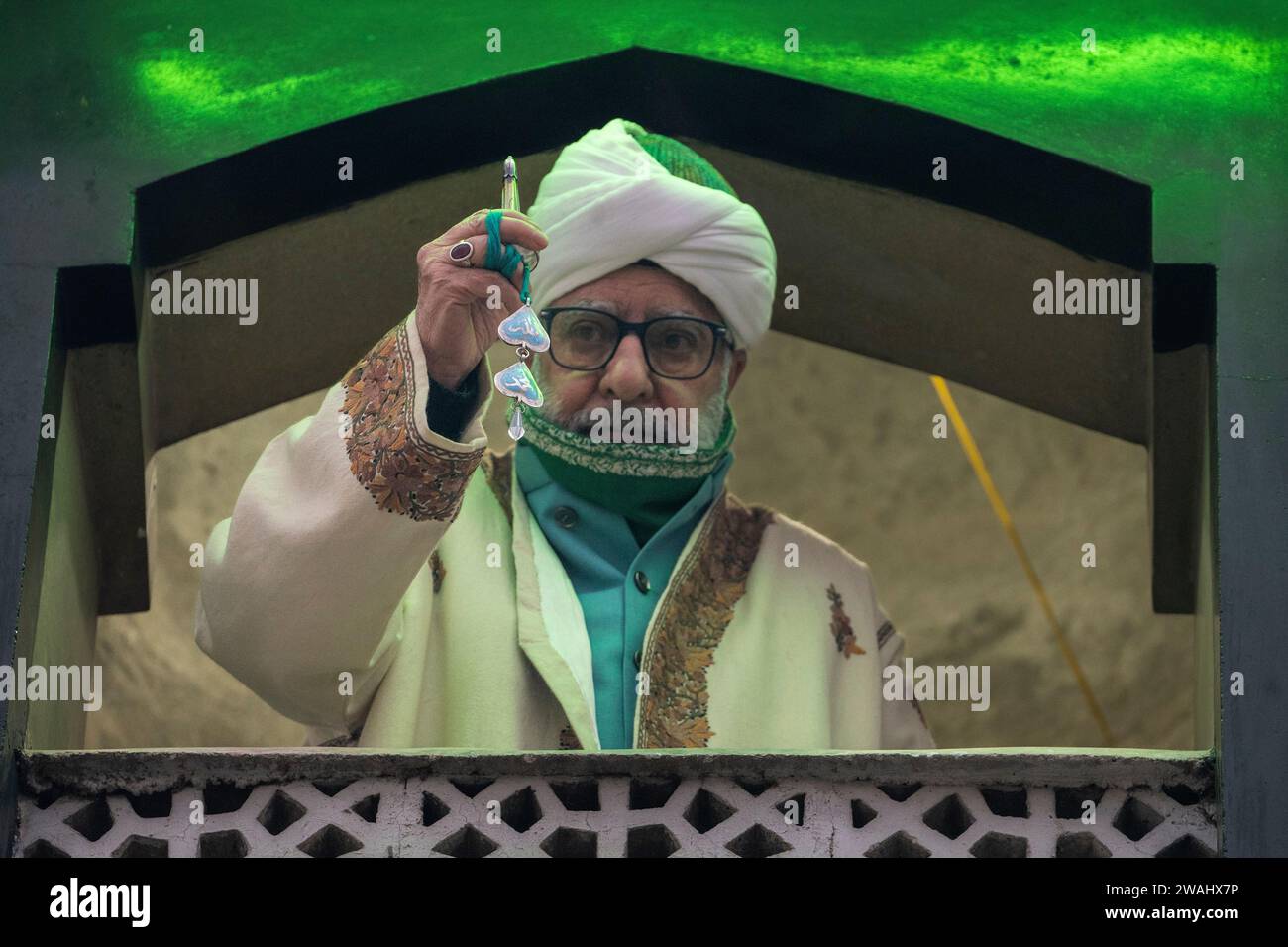 The head priest displays a relic believed to be a hair from the beard ...