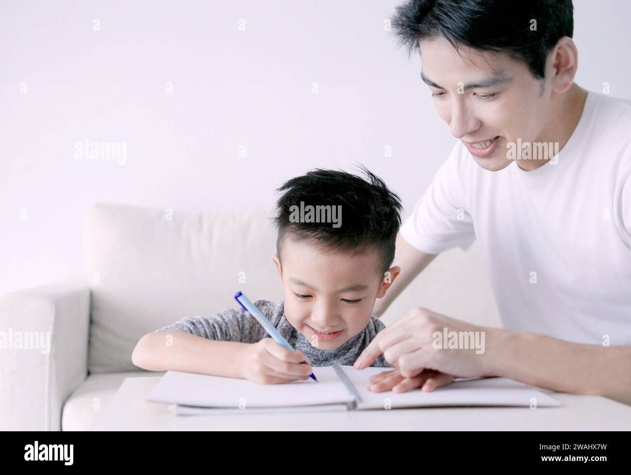 Young father checking homework helping child with study at home Stock ...