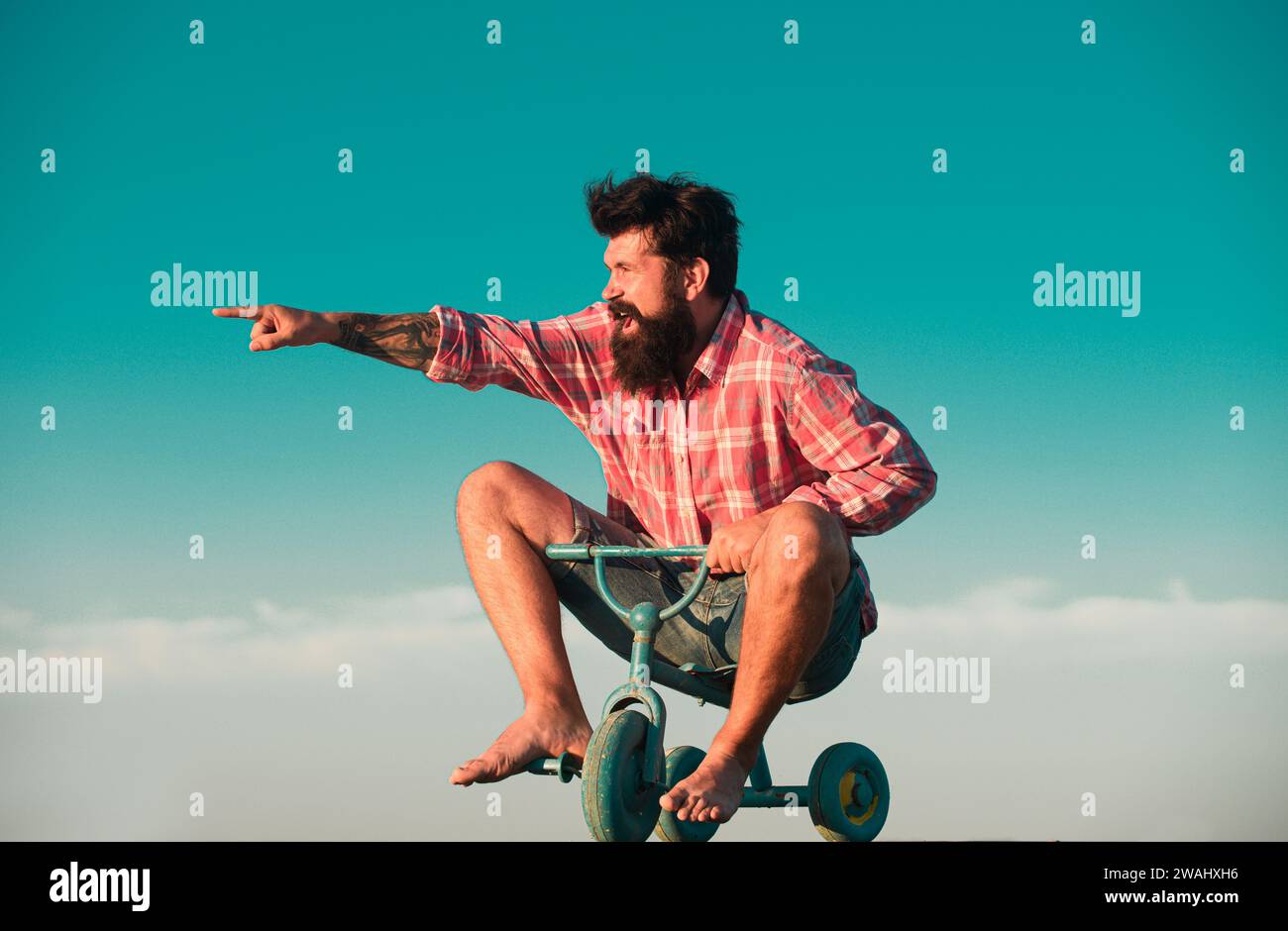 Funny man on small bicycle. Eccentric guy riding a bike Stock Photo - Alamy
