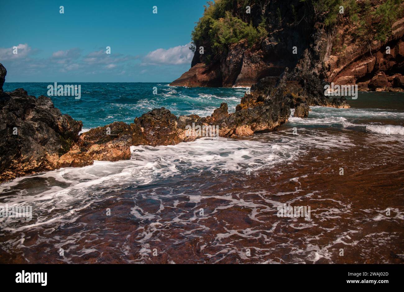 Beautiful ocean beach with large rocks on the shore and in the water ...