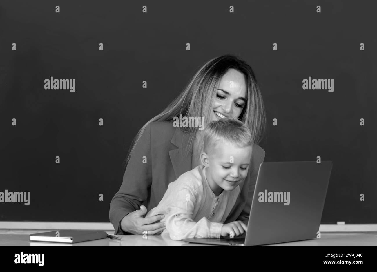 Mother and son learning. Online school. Teacher helping school child ...