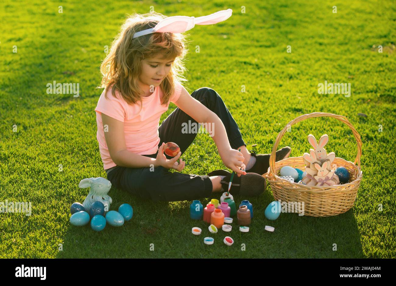 Children celebrating easter. Kid in rabbit costume with bunny ears ...