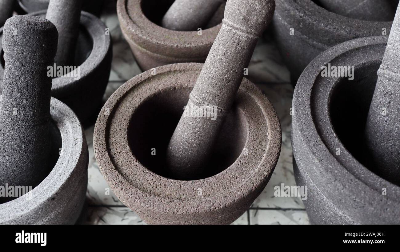 Indonesian traditional kitchenware named cobek and ulekan. stone mortar ...