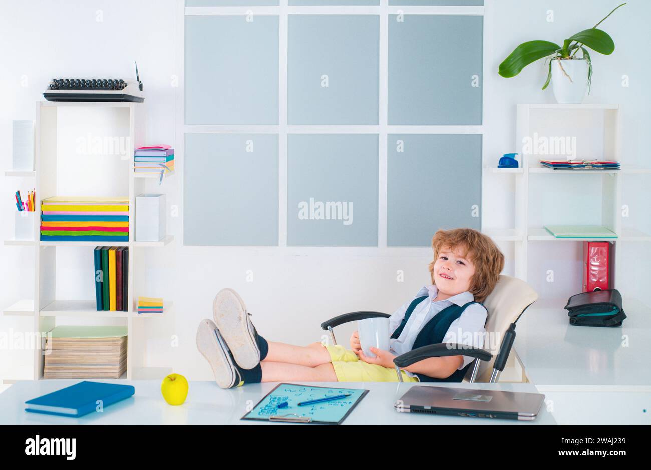 Office life. Little kid boy businessman wearing in formalwear reading ...