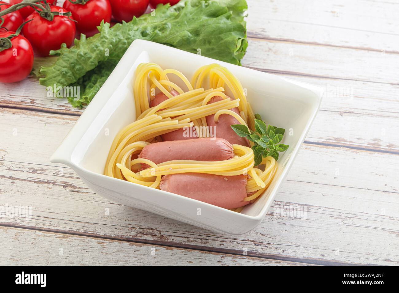 Mini sausages with pasta spaghetti for kids Stock Photo - Alamy