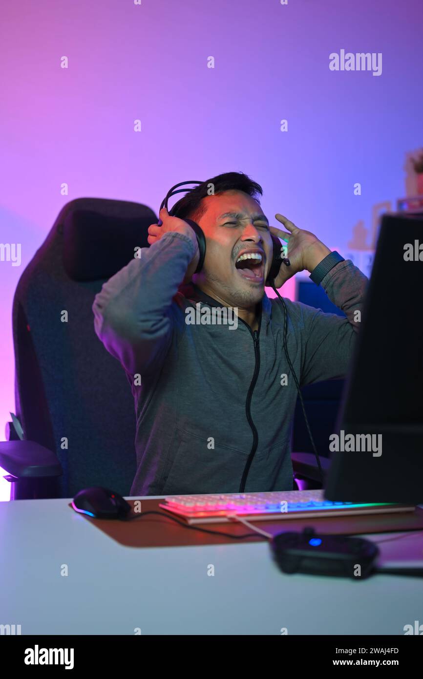 Excited player celebrating cyber success hi-res stock photography and ...