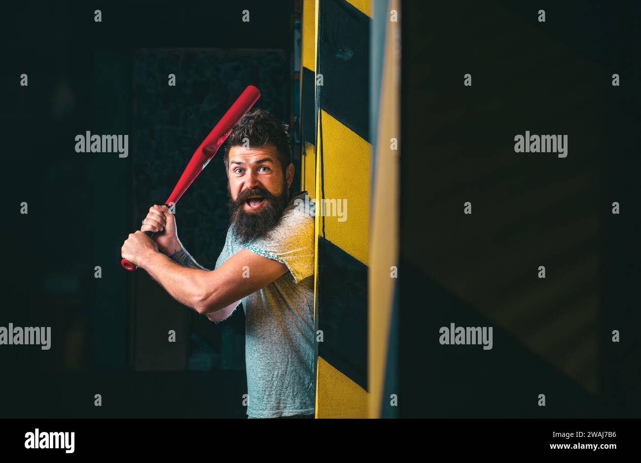 Portrait of danger aggressive man fighting with bat. Gang crime attack ...