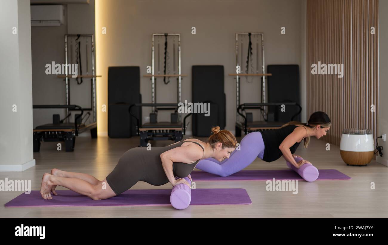 Two pregnant women do a plank with bolsters. Yoga for pregnant women ...