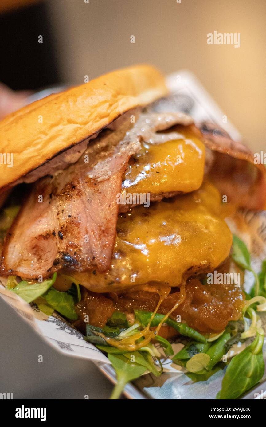 Gourmet beef burger with melted cheddar, crispy bacon, caramelized ...