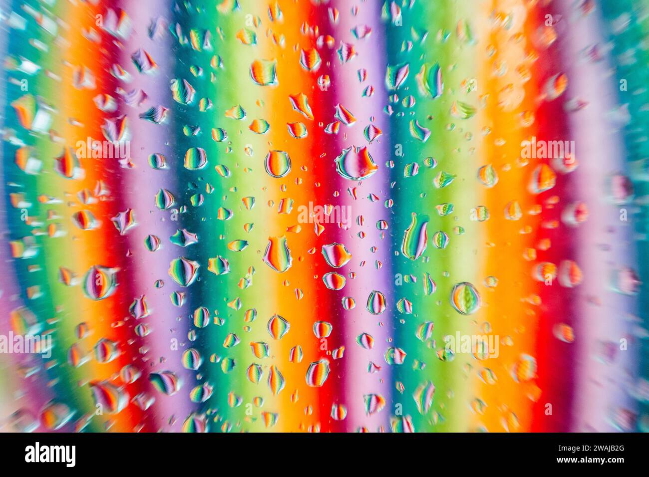 Water droplets on a glass surface with a blurred background showcasing ...