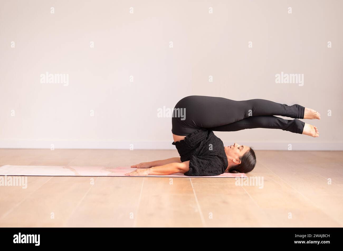 Side view of fit lady in activewear bending and stretching arms and ...