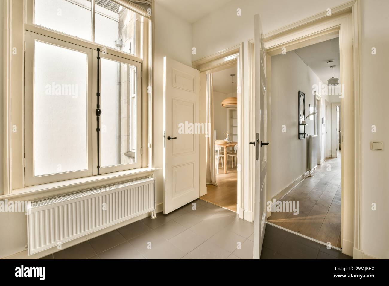 Open doors and bright window in modern hallway of luxurious apartment ...