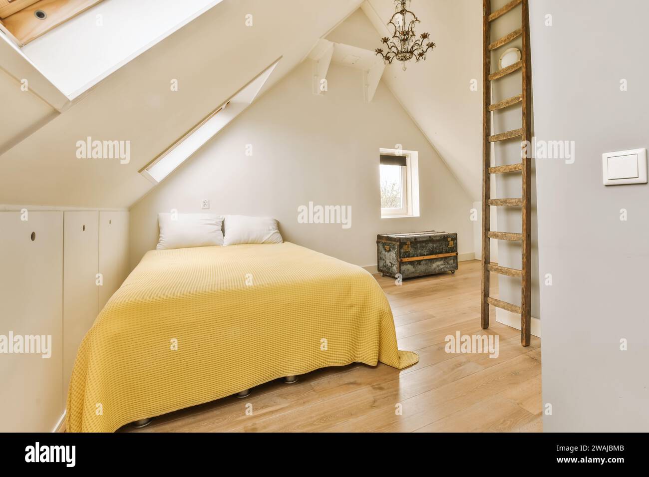 Comfortable yellow bed and wooden ladder in spacious attic bedroom ...