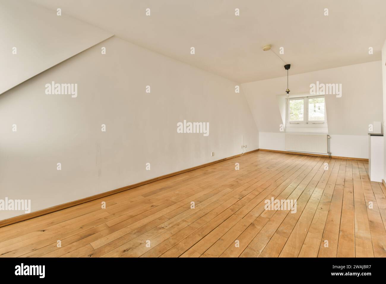 Interior of spacious empty living room with white walls and hardwood ...