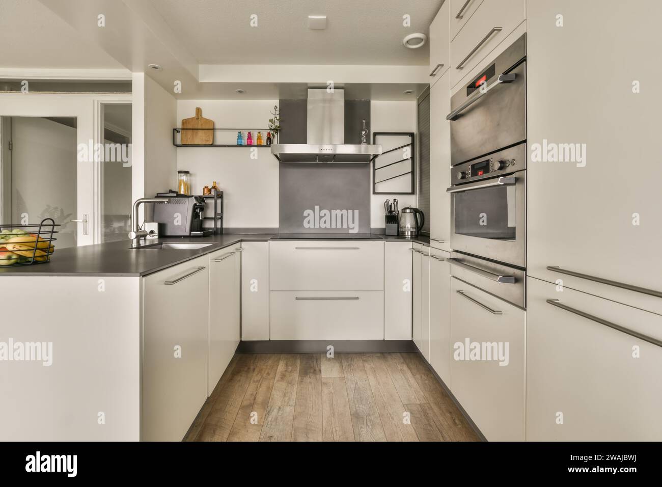 Microwave and oven in modern kitchen at luxurious apartment with sink ...