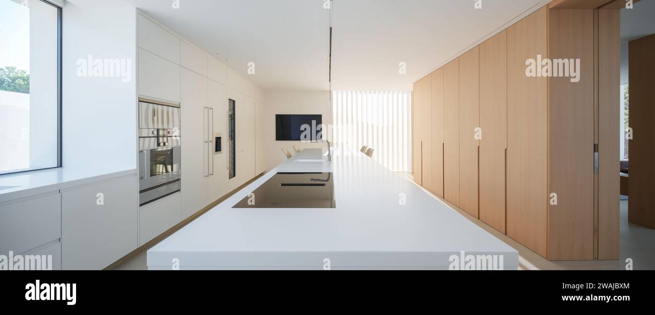 Sleek modern kitchen with clean white lines, integrated appliances, and ...